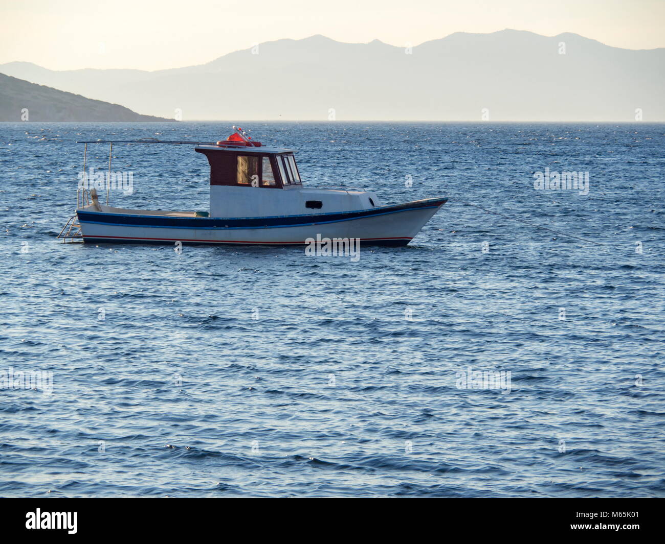 Empty boat waiting on Egean sea Stock Photo - Alamy