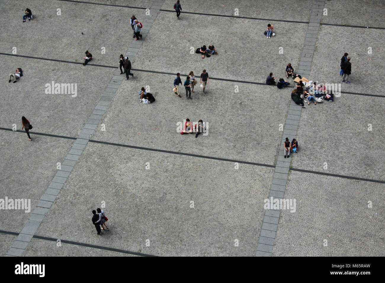 People sitting on the pavement Stock Photo - Alamy