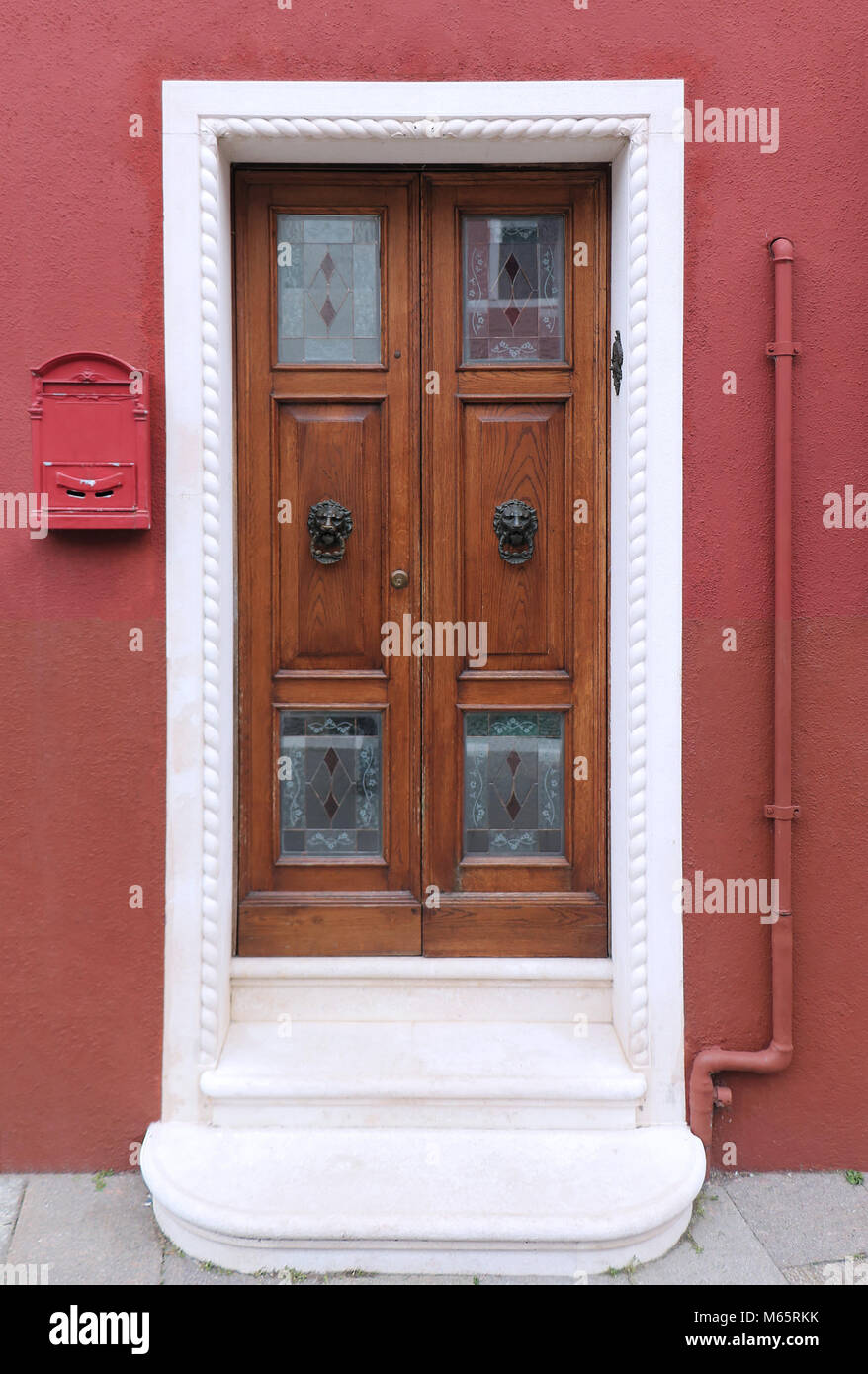 Old closed entrance wooden door exterior with letter box on the facade ...