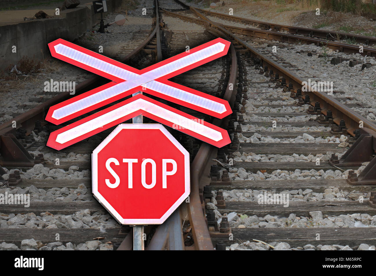 Railway crossing stop sign with empty rail tracks on the background ...