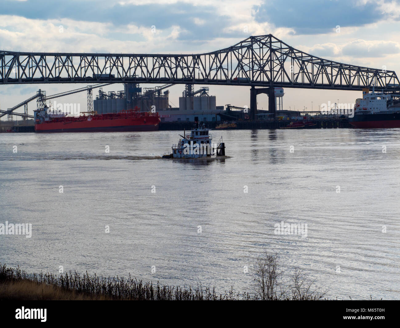 Tug boat on the River with bridge and blue sky, clouds Stock Photo - Alamy