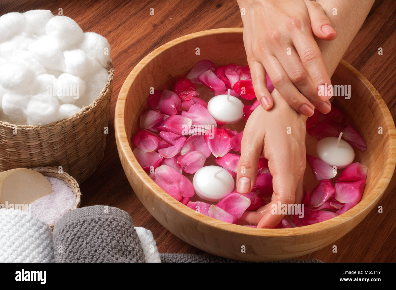 Female hands and bowl of spa water with flowers, hand care in nail ...