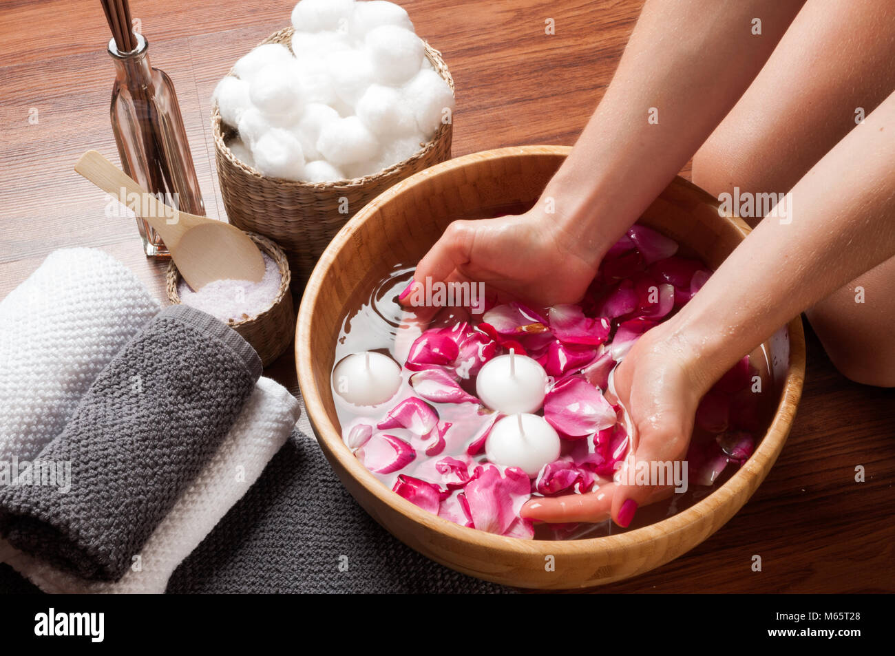 Female hands and bowl of spa water with flowers, hand care in nail ...