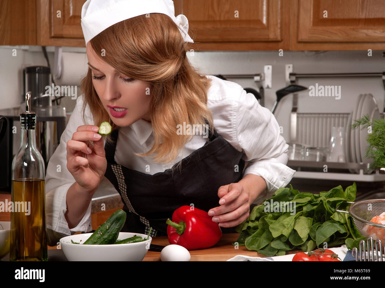 Woman cooking in kitchen making healthy food with vegetables Stock ...