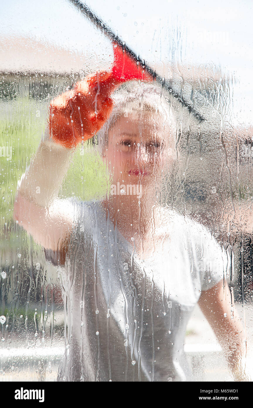 Smiling attractive wife washing window hi-res stock photography and ...