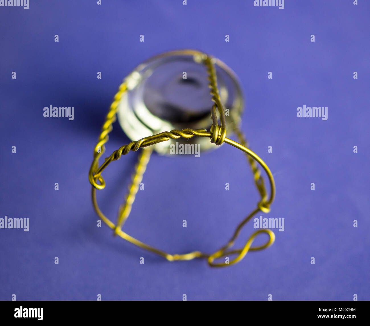 Muselet from bottle of champagne. Isolated on blue background ...