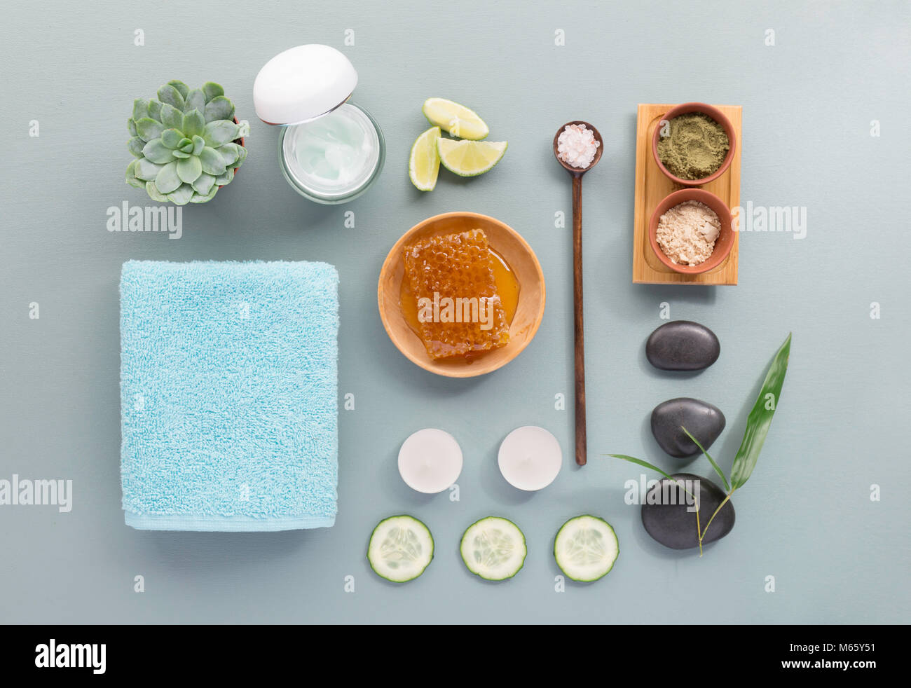 From above different products and equipment for spa procedure on gray ...