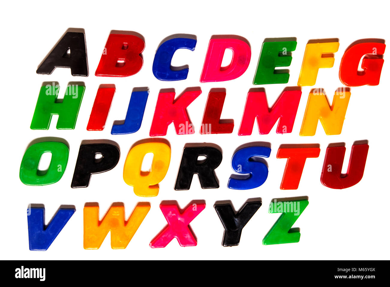 Plastic colorful letters isolated on a white background Stock Photo - Alamy