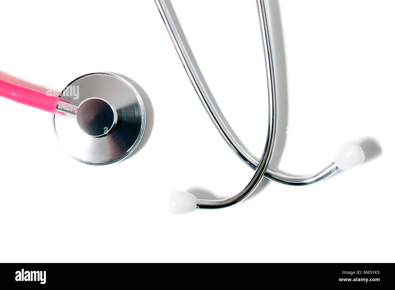 Close up view of a pink doctor's stethoscope isolated on a white ...