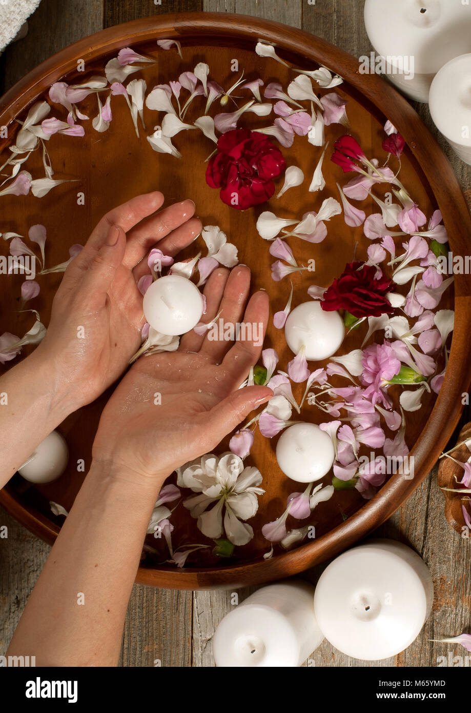Female hands in bowl of water with flowers, spa salon Stock Photo - Alamy
