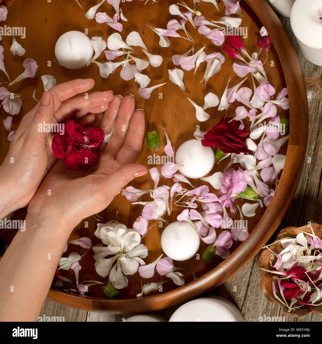 Female hands in bowl of water with flowers, spa salon Stock Photo - Alamy