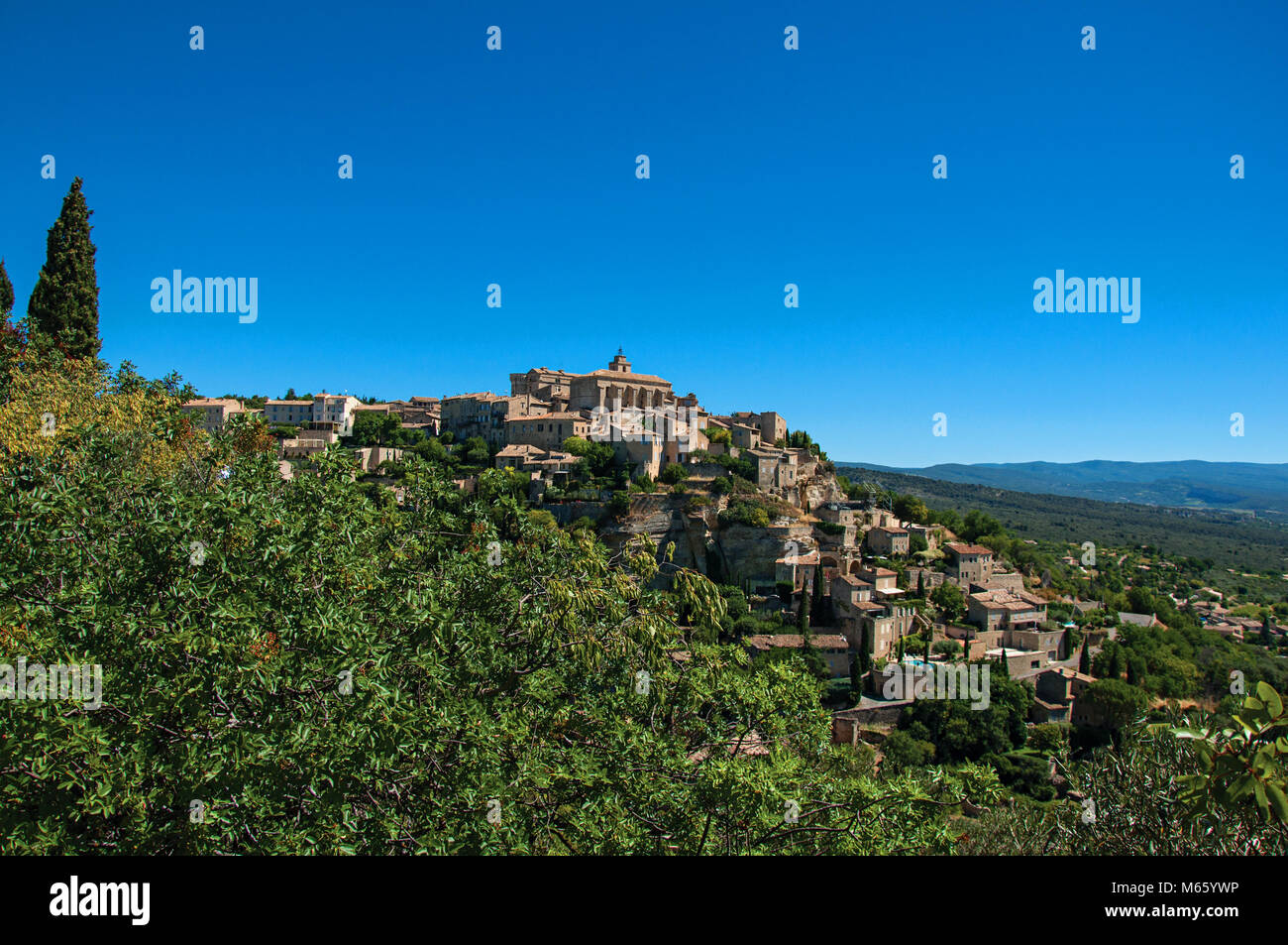 Panoramic view of the village of Gordes on top of a hill and under ...