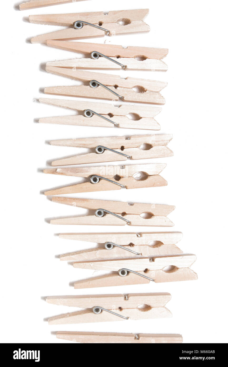 Aligned clothing pegs isolated on a white background Stock Photo - Alamy