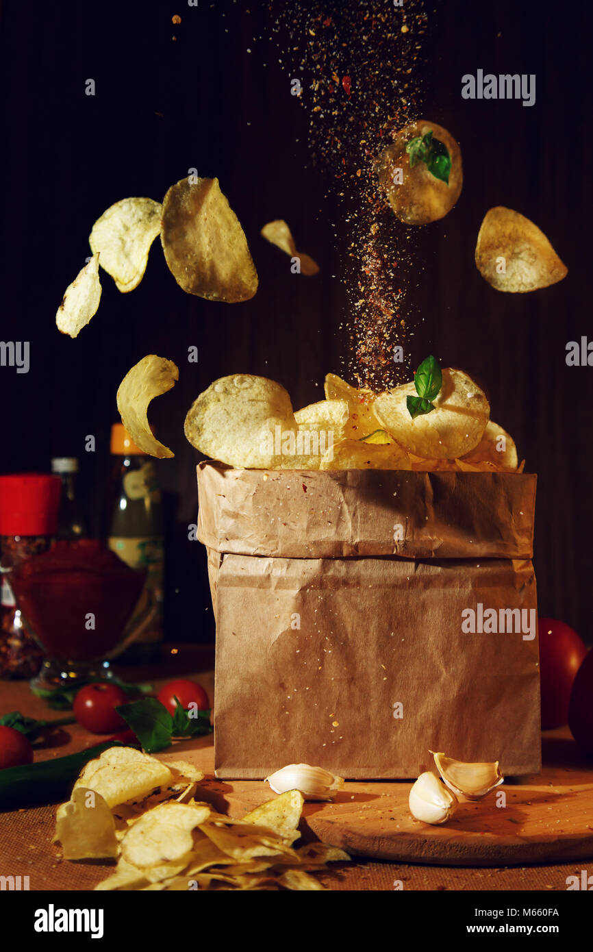Flying chips on a dark background. The image can be used in advertising ...