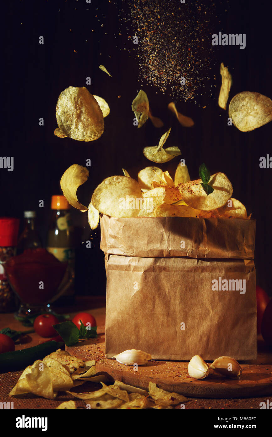 Flying chips on a dark background. The image can be used in advertising ...