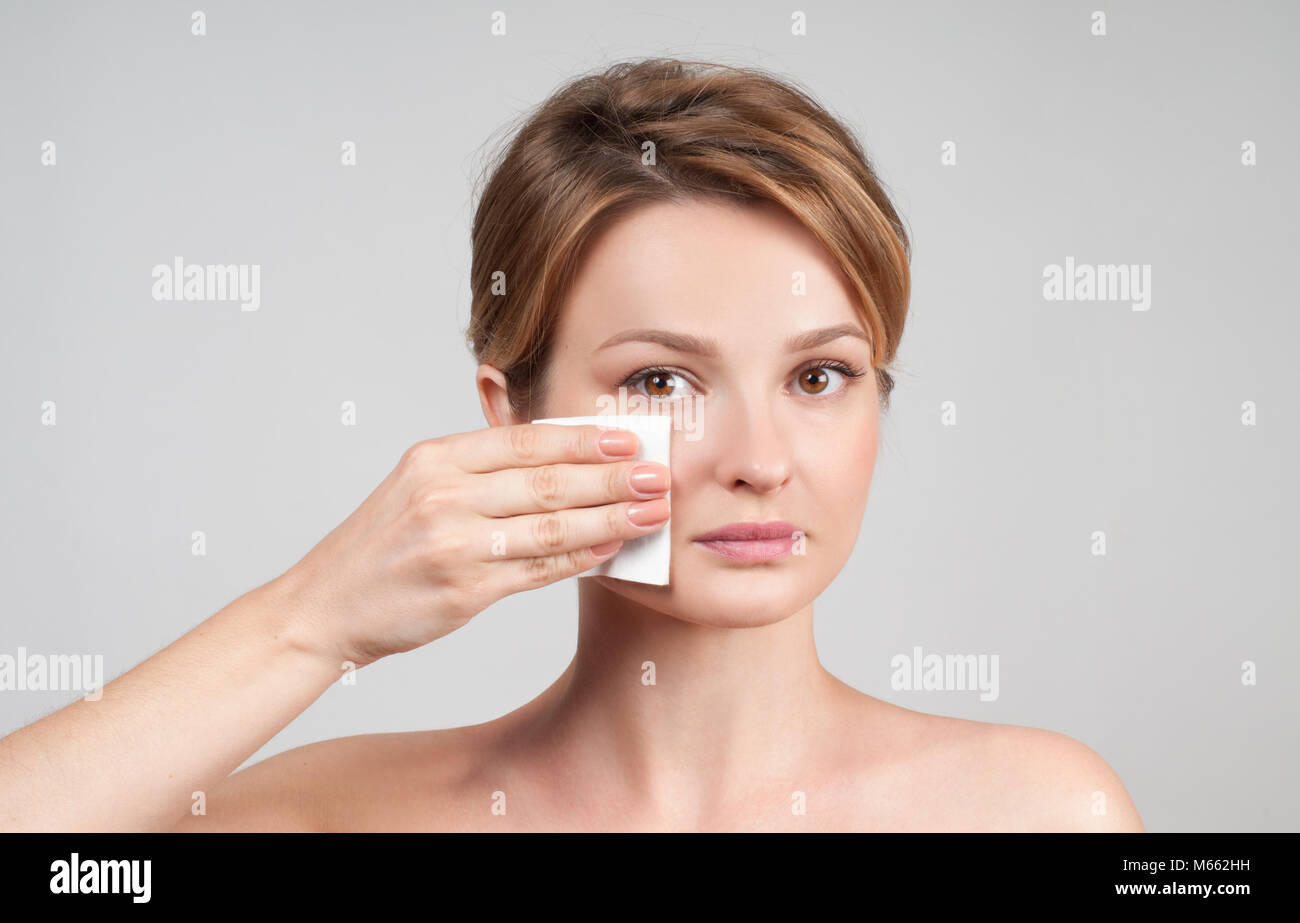 Beauty. Skin care concept. Woman removing makeup from her face with ...