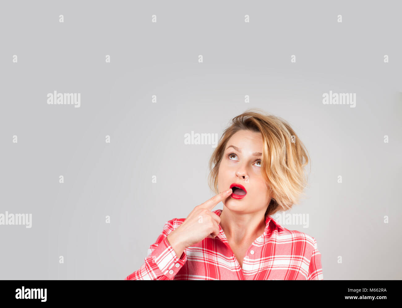 Portrait of business lady looking up. Beautiful thinking woman has ...