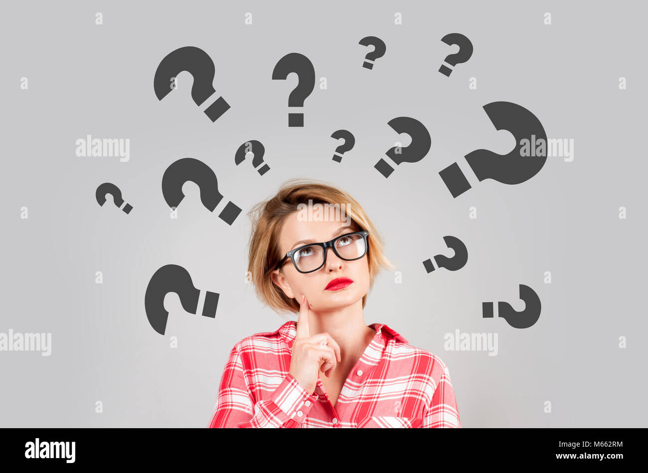 Thinking woman with questioning expression and question marks above her ...