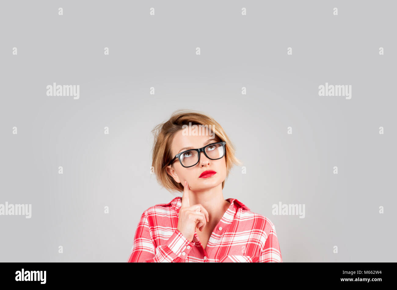 Portrait of business lady looking up. Beautiful thinking woman has ...