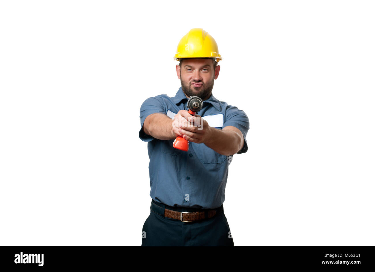 Contractor. Man in uniform and yellow helmet with drill Stock Photo - Alamy
