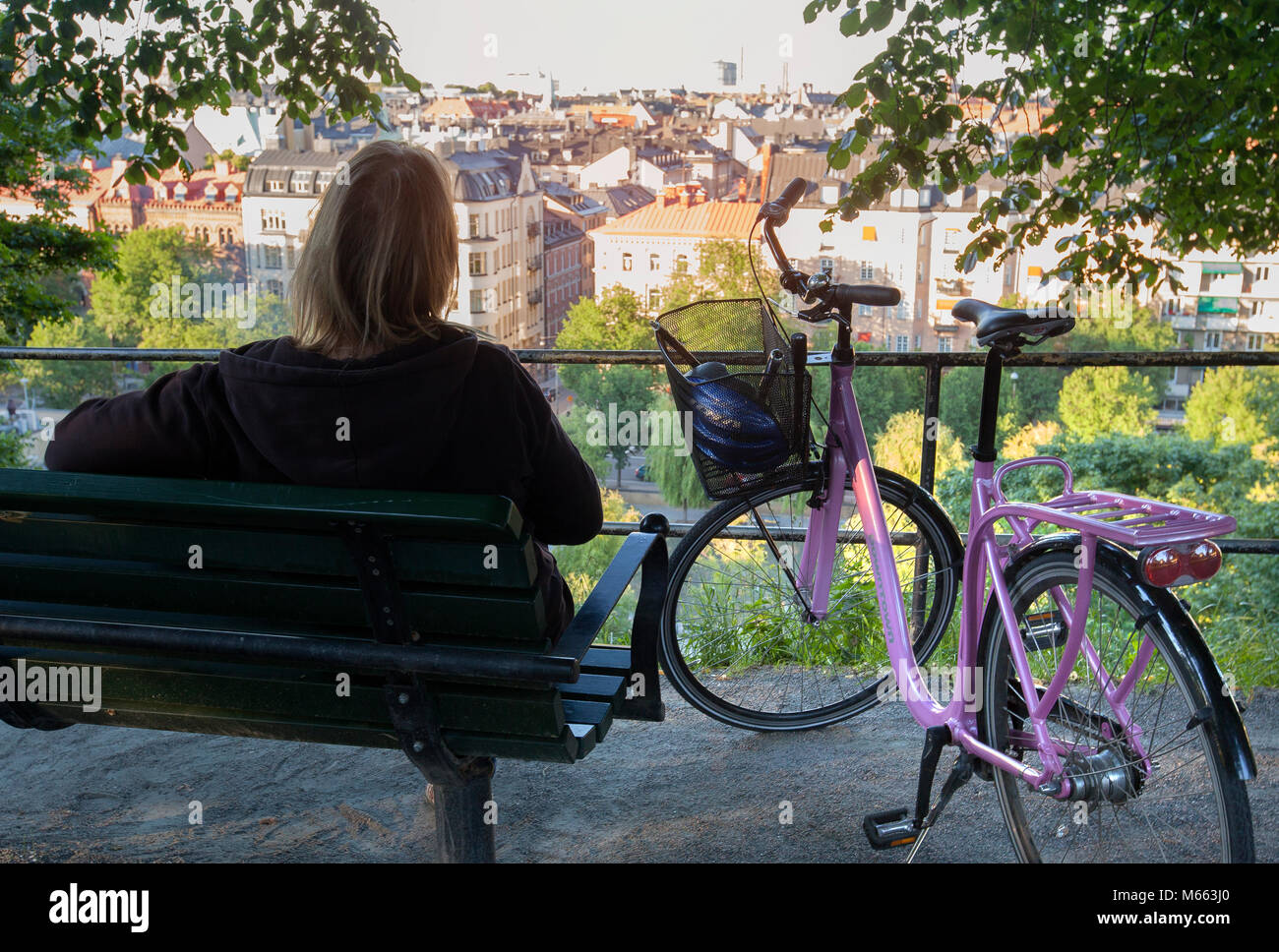 A woman stops for rest with her bicycle in Stockholm city Stock Photo ...