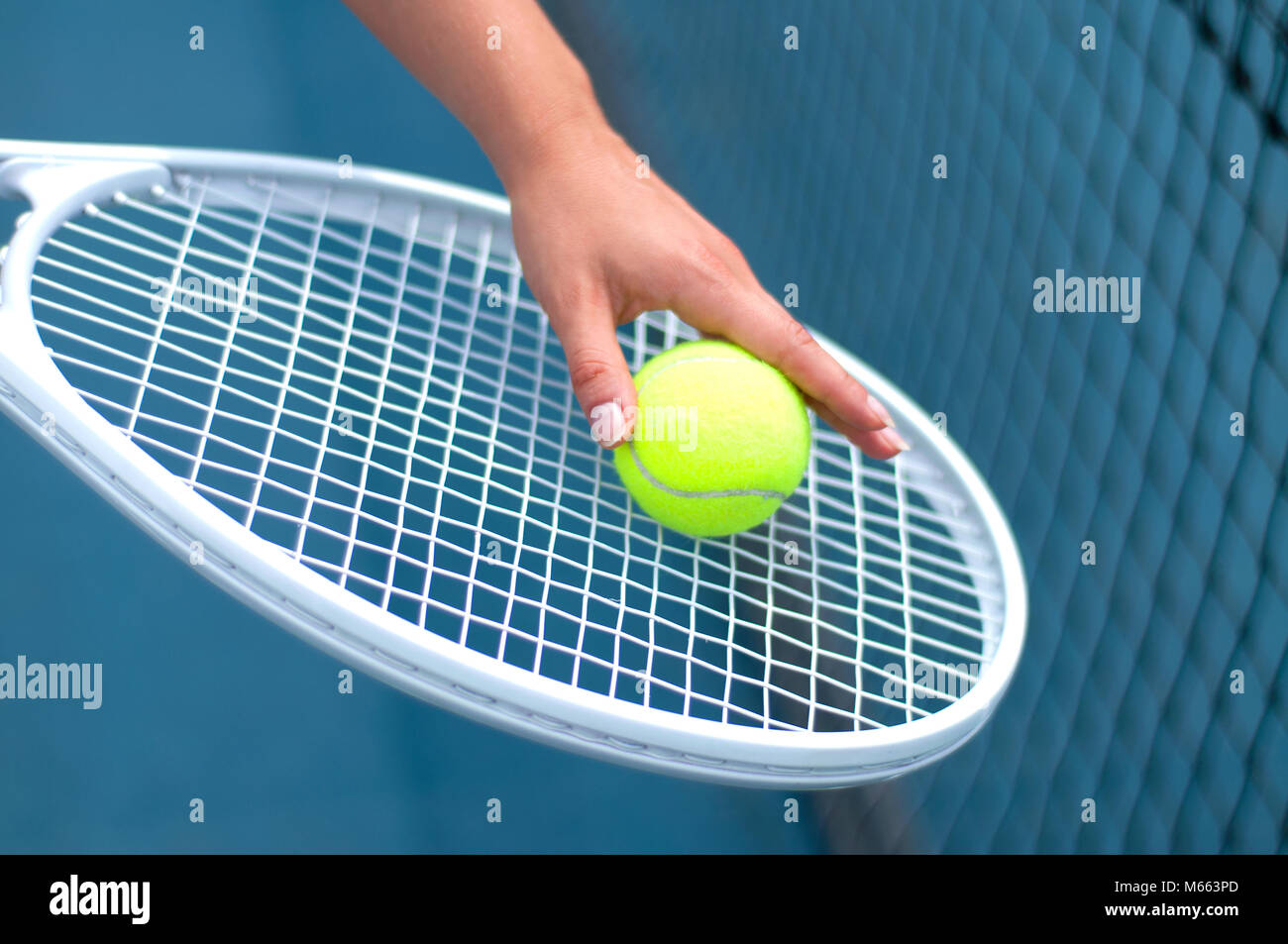 Tennis player holding tennis ball and racket in hand on the tennis ...