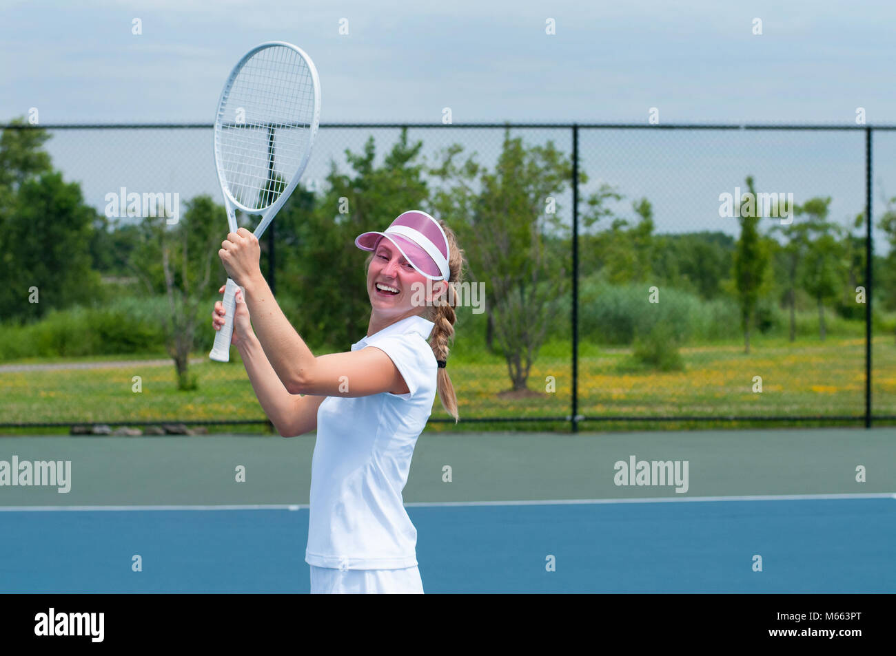 Tennis player celebrating after winning a tennis match. Young woman is ...