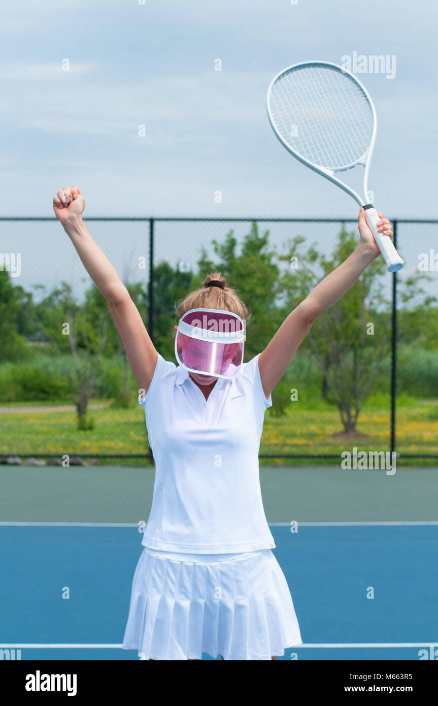 Tennis player celebrating after winning a tennis match. Young woman is ...