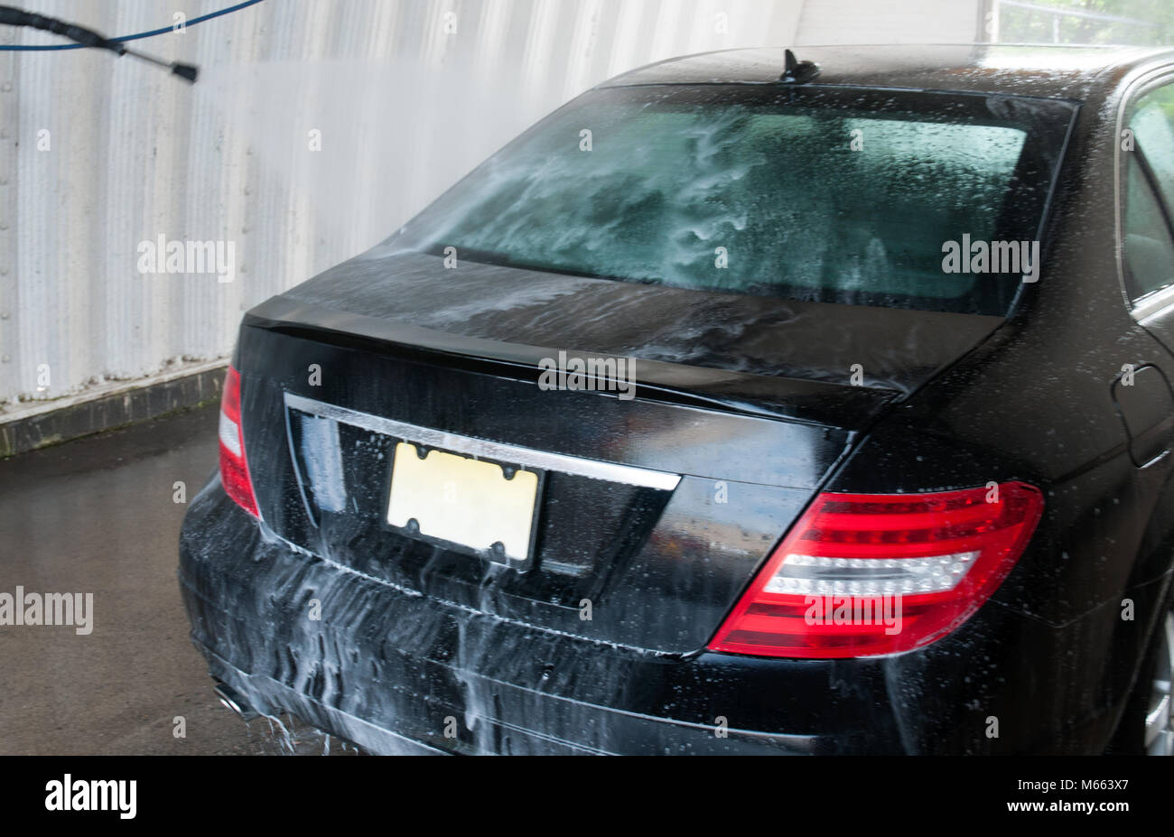 Car Washing. Closeup photo Modern Car Covered by Water Stock Photo - Alamy