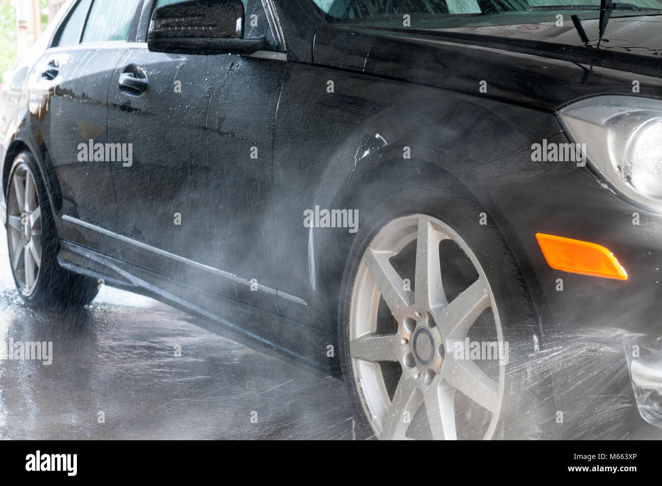Car Washing. Closeup photo Modern Car Covered by Water Stock Photo - Alamy