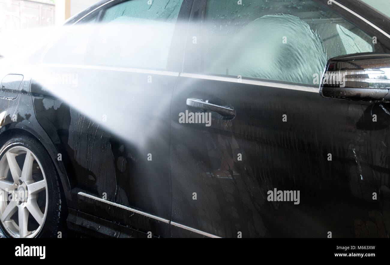 Car Washing. Closeup photo Modern Car Covered by Water Stock Photo - Alamy
