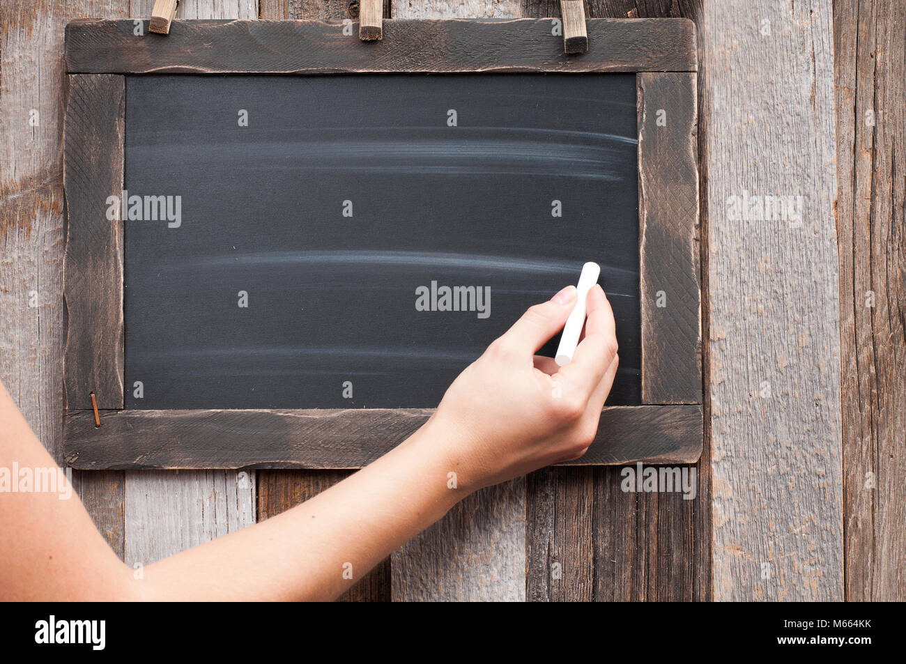 Female hand to draw something on blackboard with chalk Stock Photo - Alamy