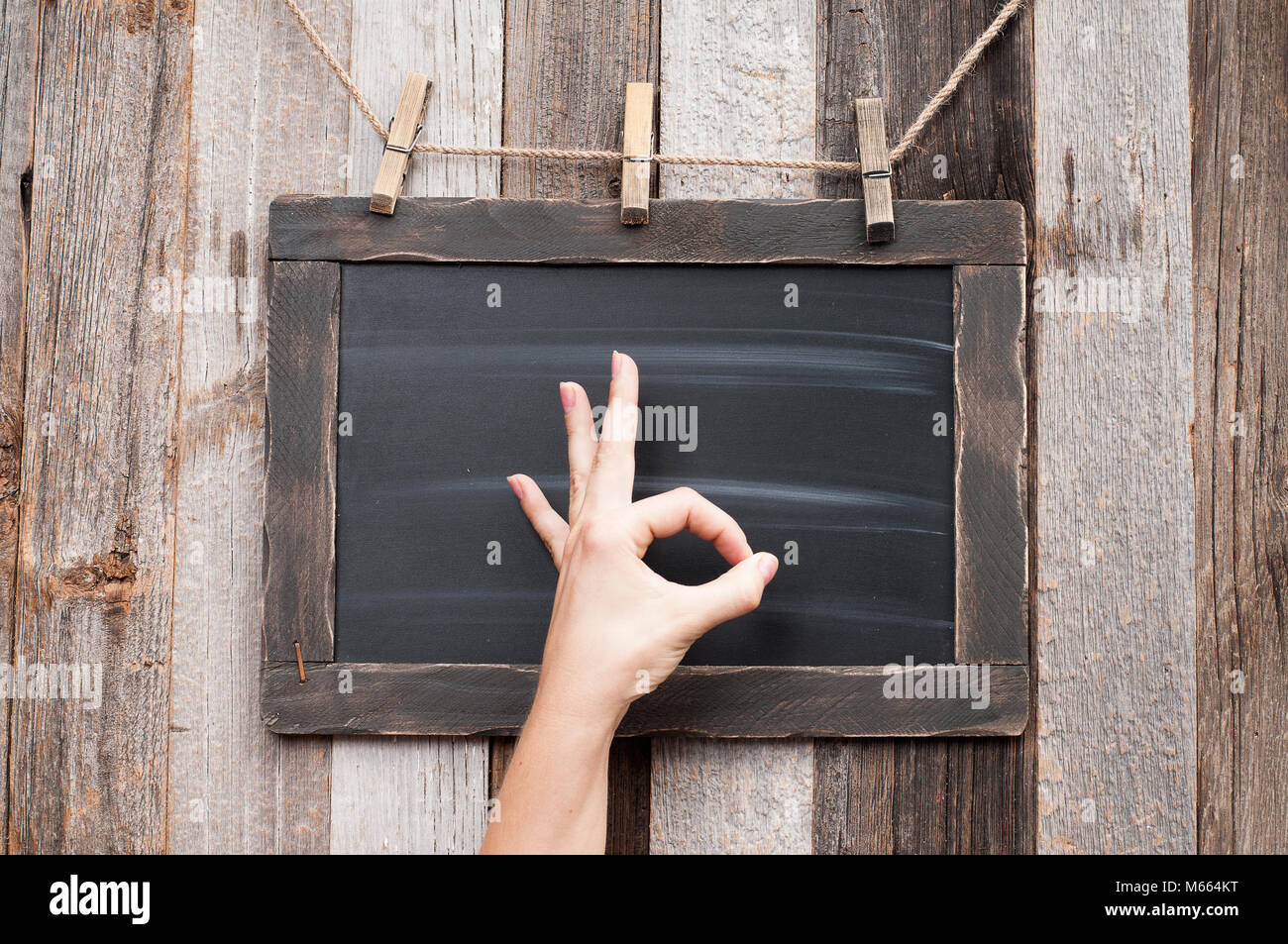 Closeup woman hand making OK sign on chalkboard Stock Photo - Alamy