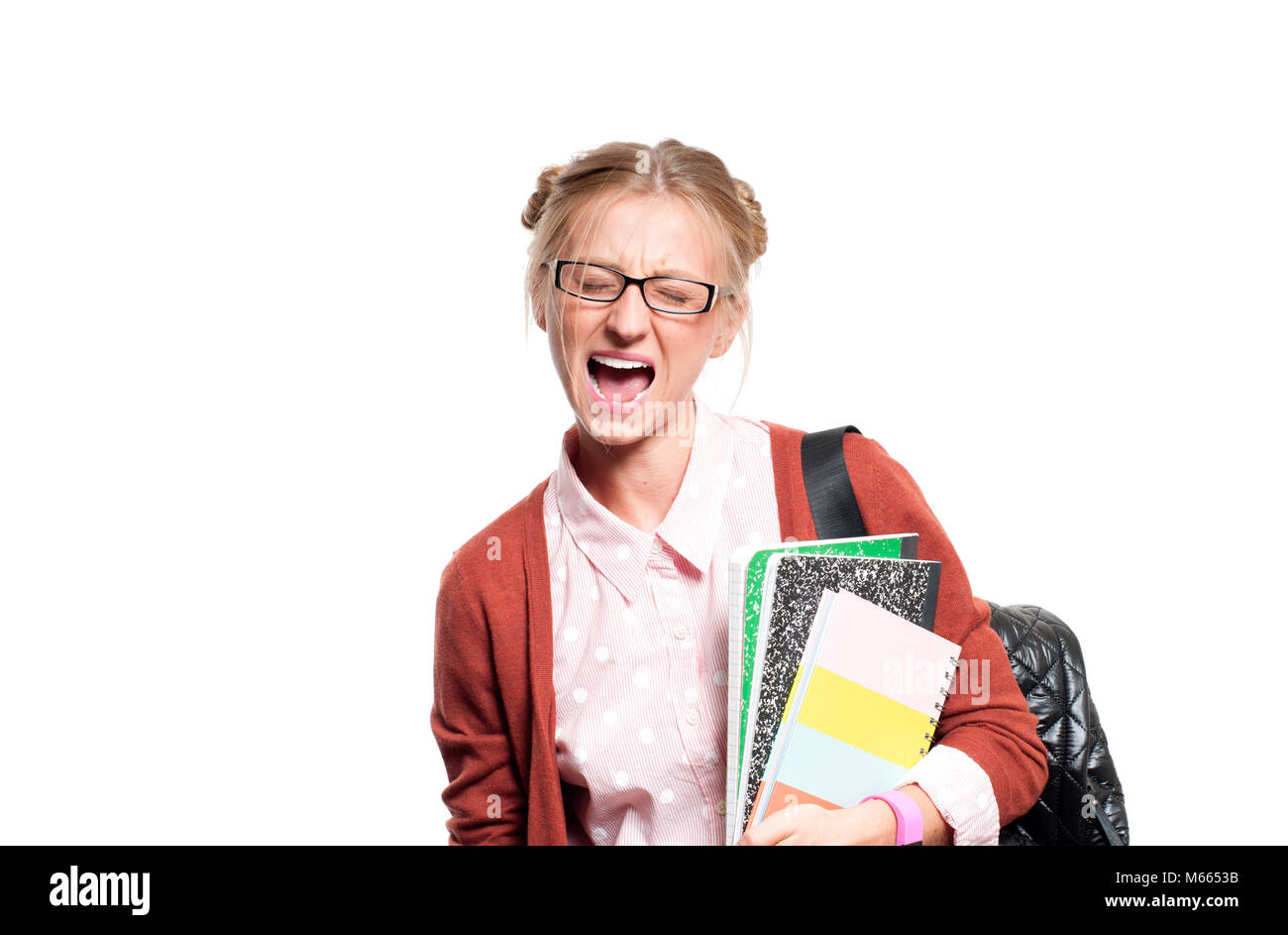 Annoyed young student girl holding books, standing isolated on white ...