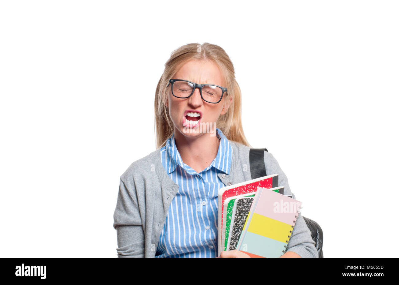 Annoyed young student girl holding books, standing isolated on white ...