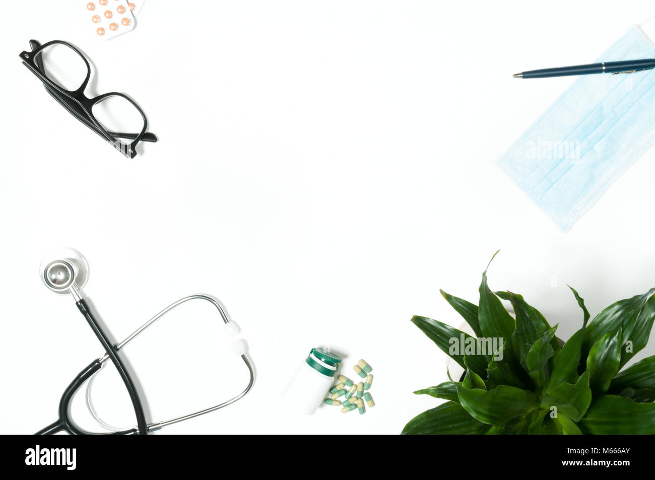 Workplace of doctor - stethoscope, medical items and pills on desk ...