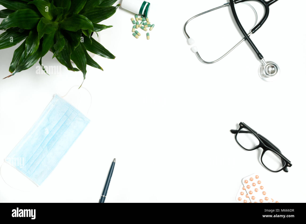 Workplace of doctor - stethoscope, medical items and pills on desk ...