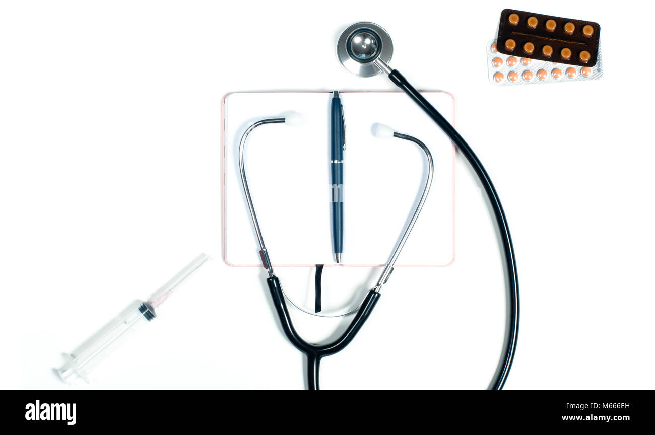 Workplace of doctor - stethoscope, medical items and pills on desk ...
