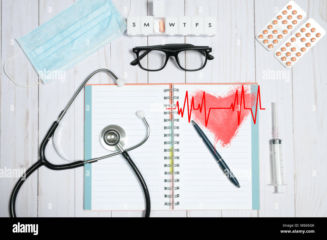 Workplace of doctor - stethoscope, medical items and pills on desk ...