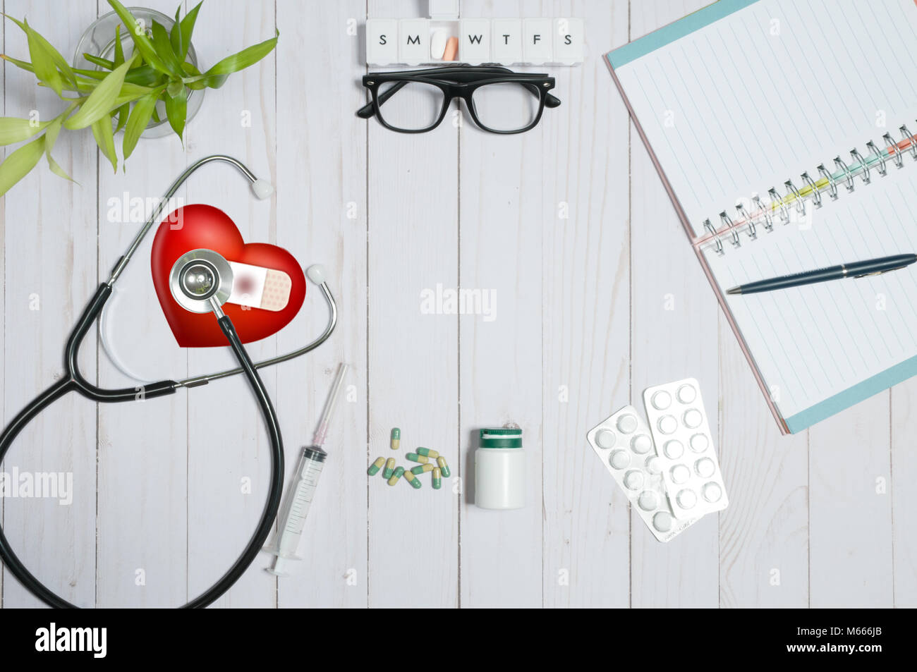Workplace of doctor - stethoscope, medical items and pills on desk ...