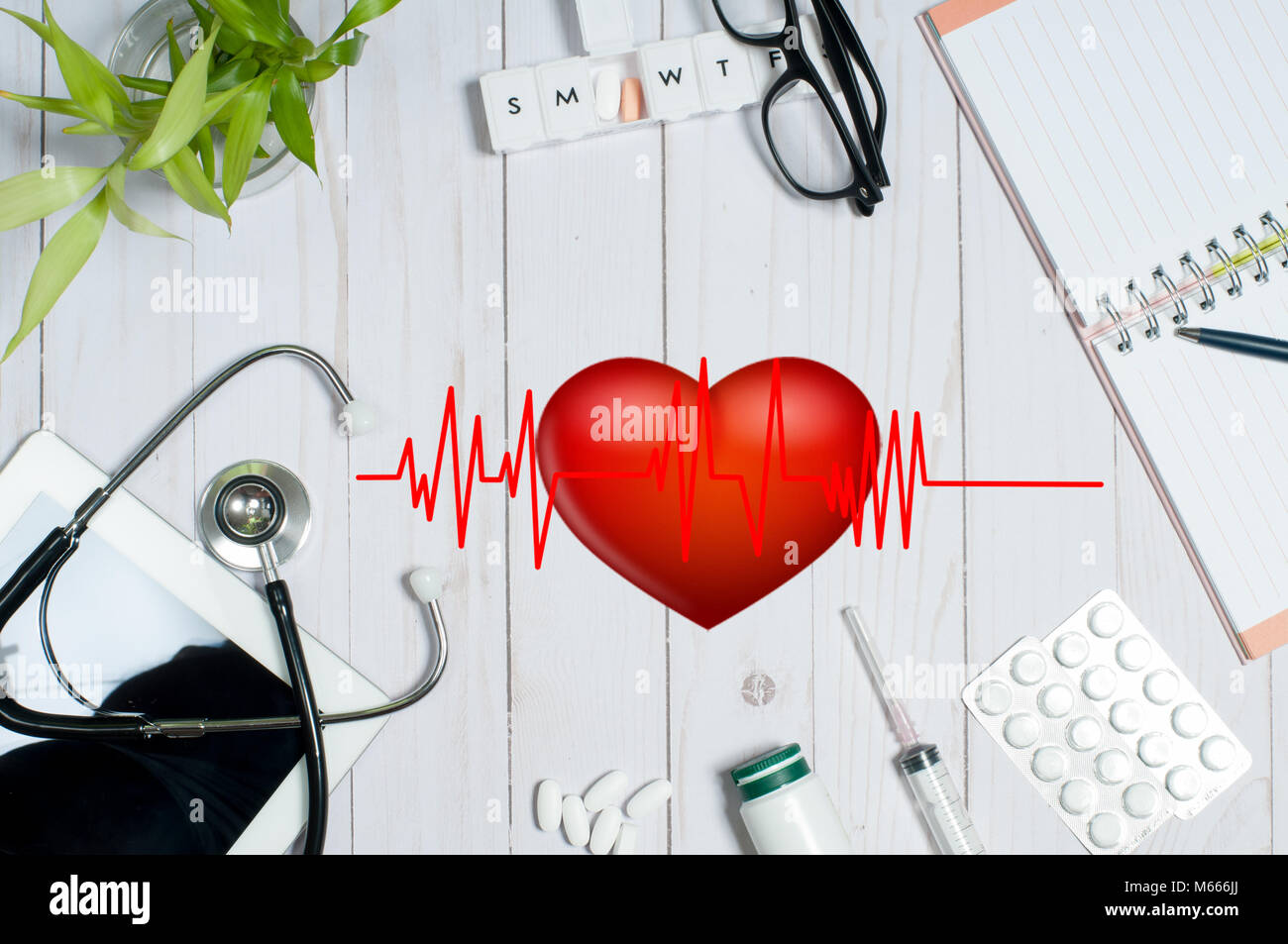 Workplace of doctor - stethoscope, medical items and pills on desk ...