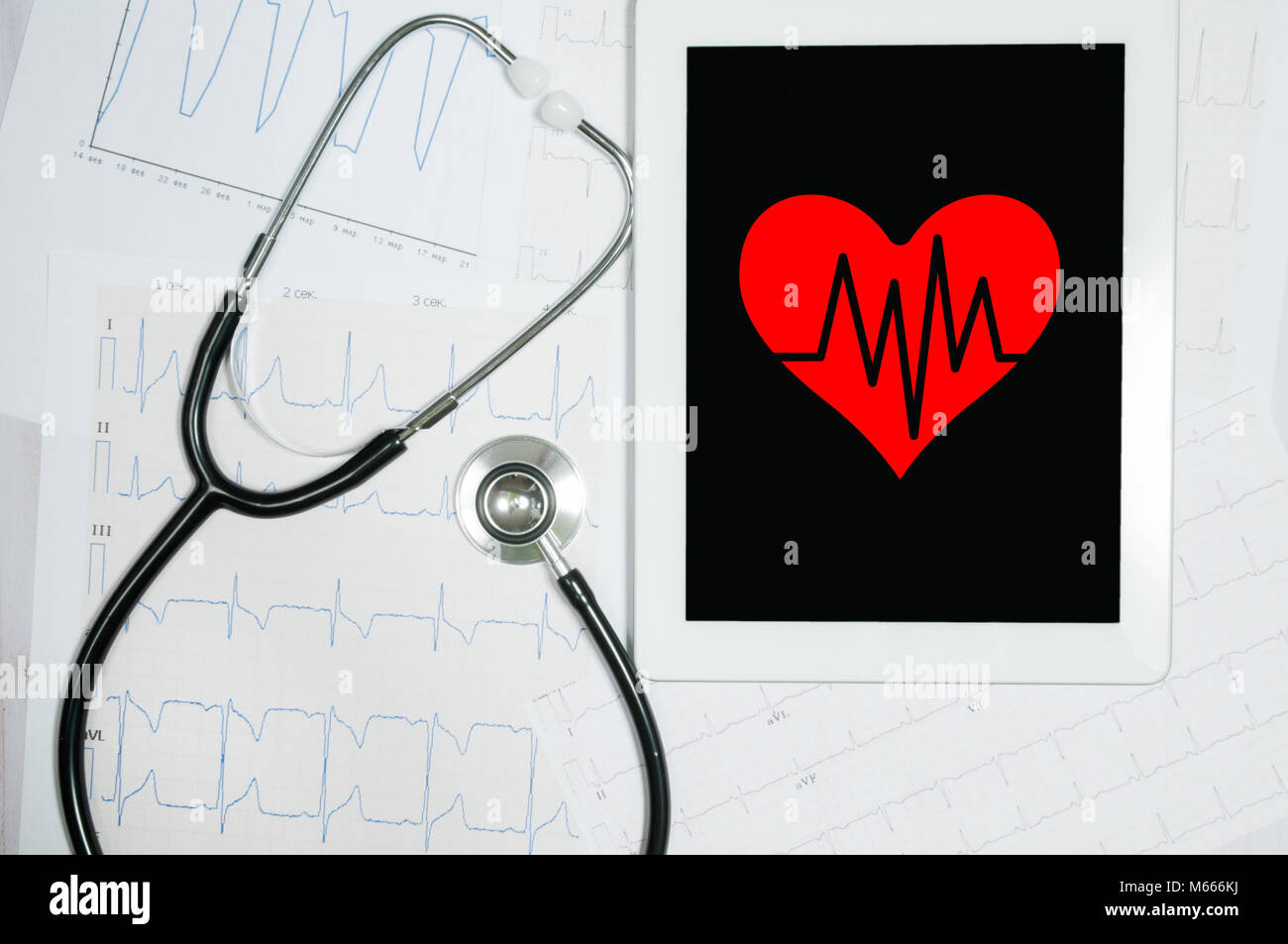 Heart on screen touch pad and stethoscope. Cardiogram chart Stock Photo ...