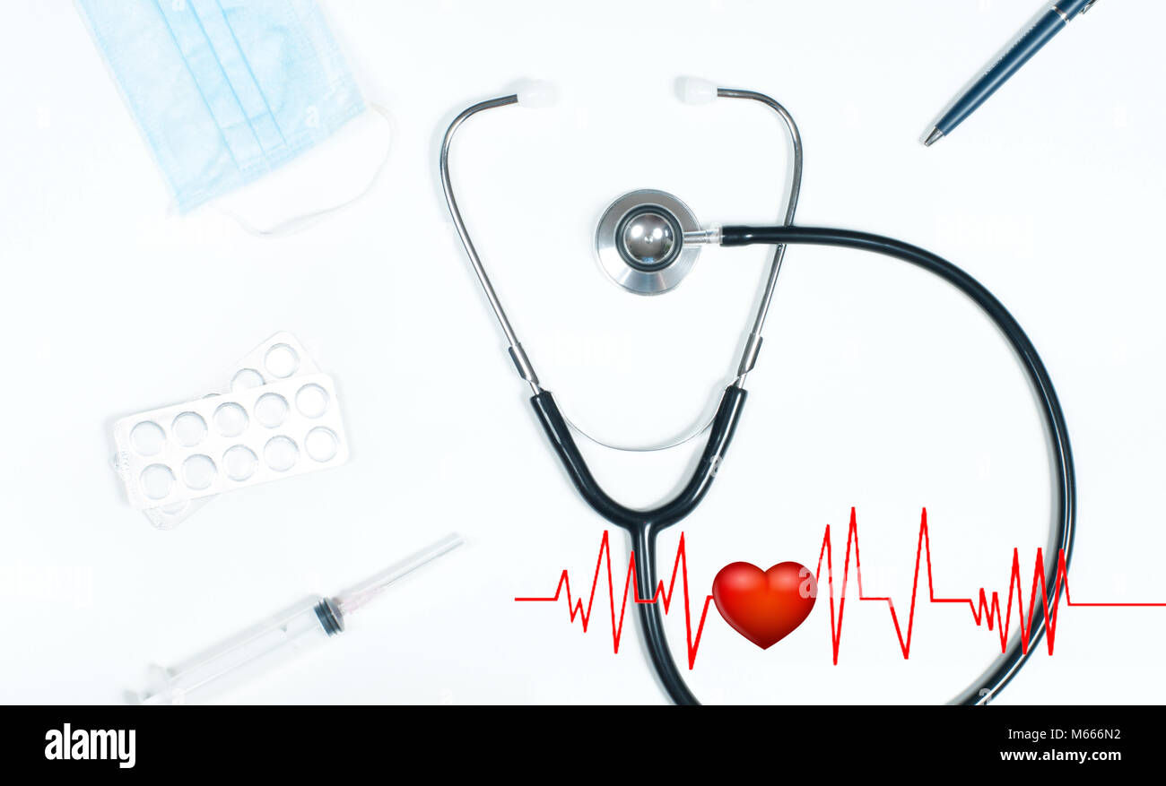 Workplace of doctor - stethoscope, medical items and pills on desk ...
