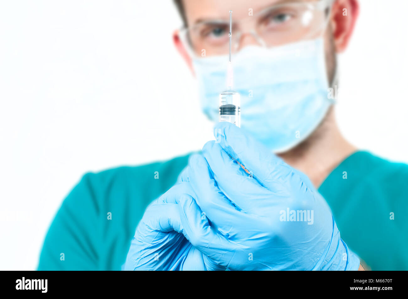 Doctor in medical mask with syringe ready to make injection Stock Photo ...