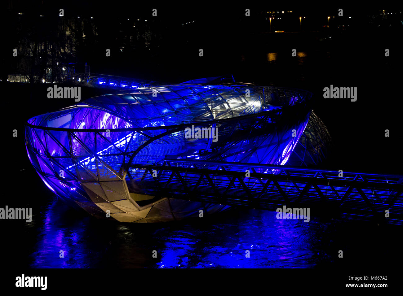 Graz, Austria - 08.02.2018: The Murinsel bridge lit up in blue color at ...