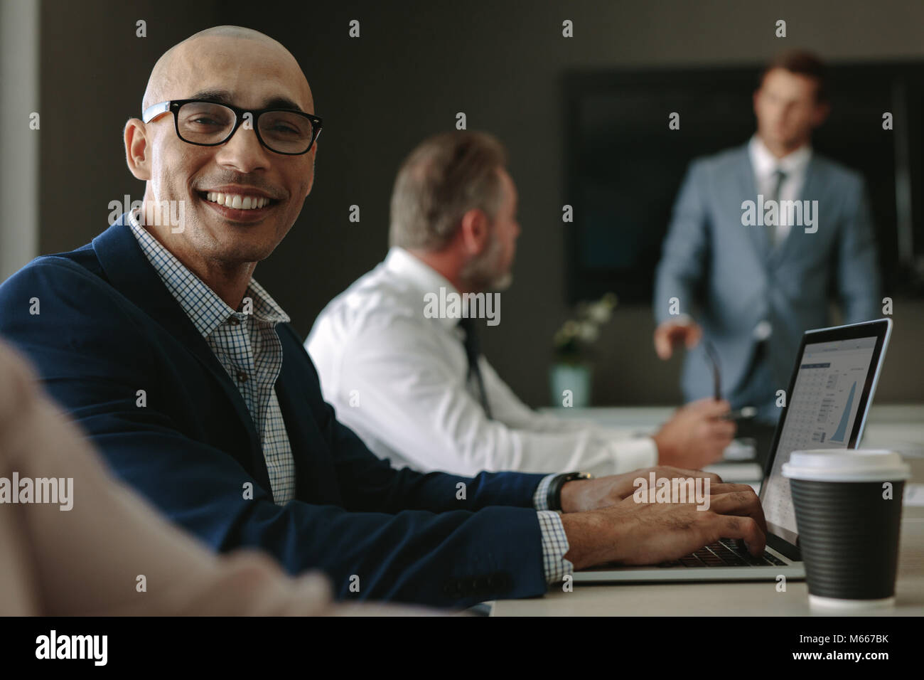 Smiling businessman during a meeting in conference room. Male executive ...
