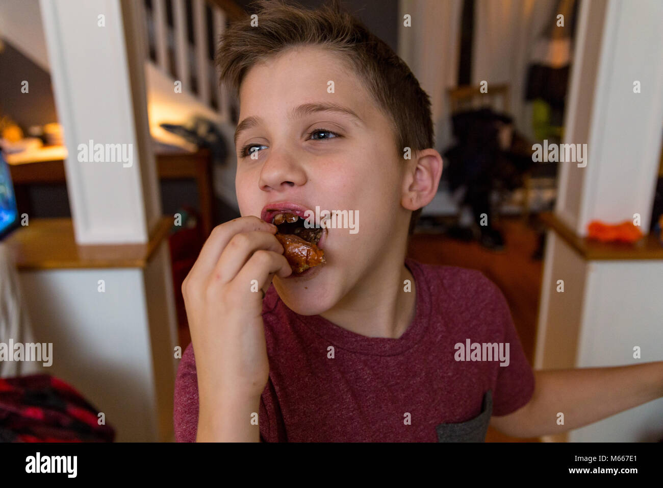 Young Caucasian Boy Makes Silly Faces While Eating Chocolate And ...