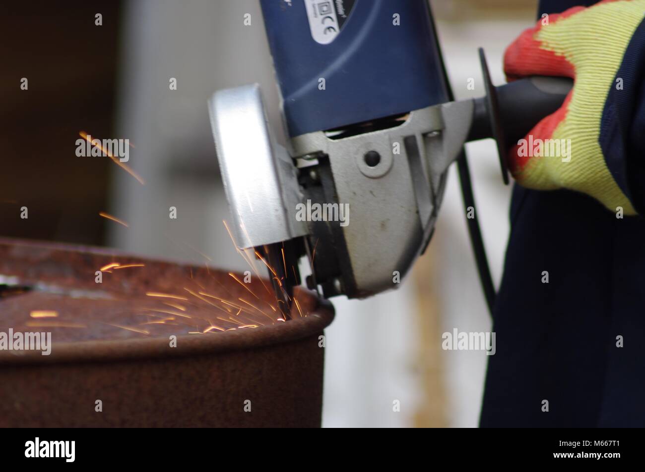 Young Man with a Power Tool Undertaking DIY Home Improvement Work in a ...