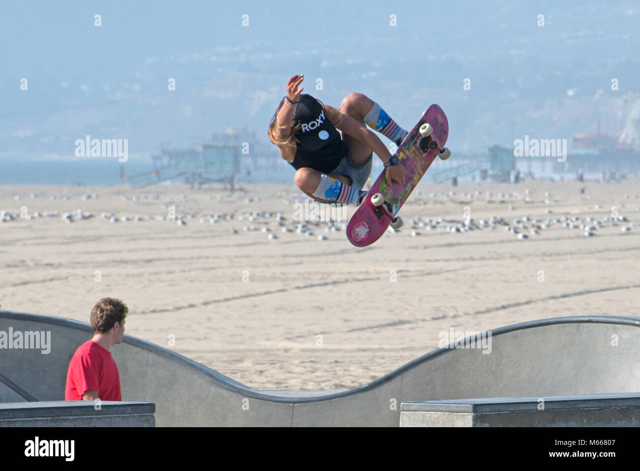 Filming a skateboarder performing tricks at Venice Beach Skatepark ...