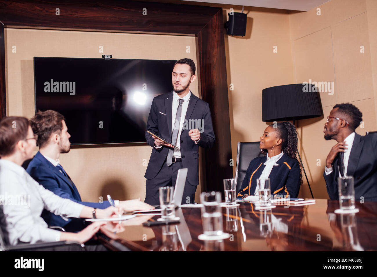 Businessman presenting to colleagues at a meeting Stock Photo - Alamy